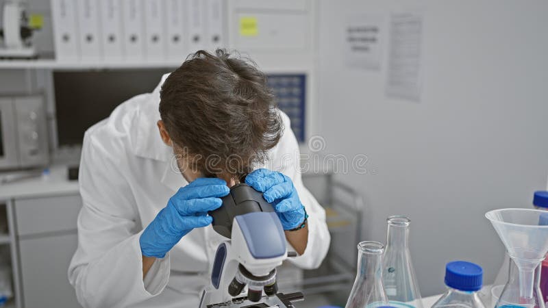 Young Arab Man Scientist Using Microscope at Laboratory Stock Photo ...