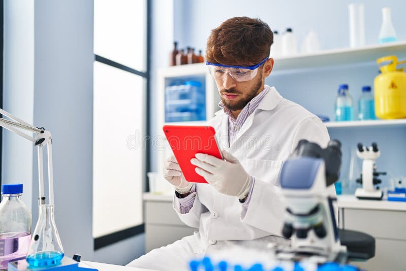 Young Arab Man Scientist Using Touchpad Working at Laboratory Stock ...