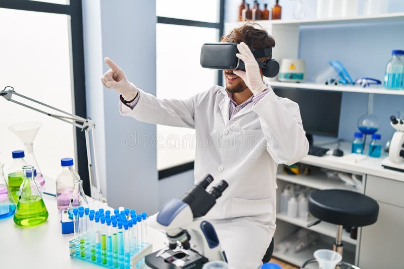 Young Arab Man Scientist Using Virtual Reality Glasses Working at ...