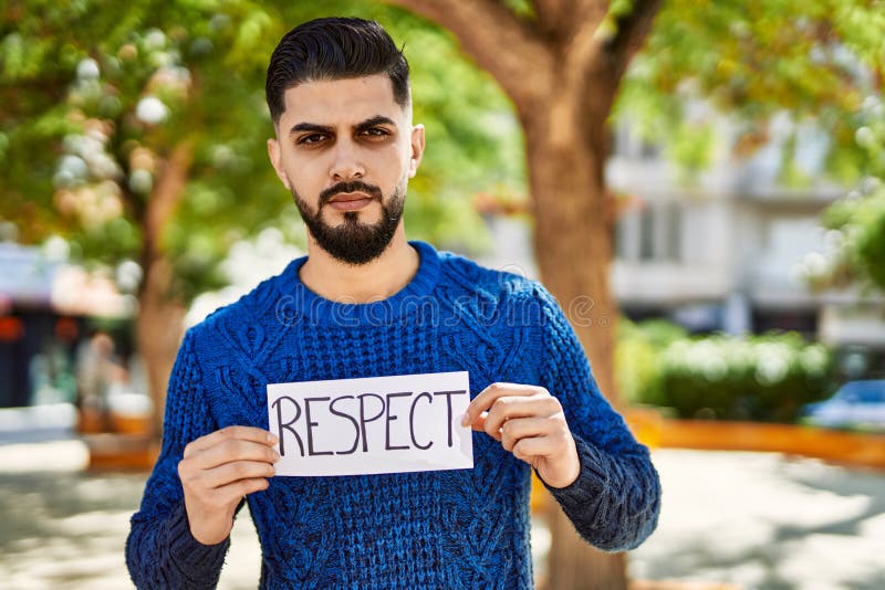 Young Arab Man Serious Holding Respect Banner at Park Stock Image ...