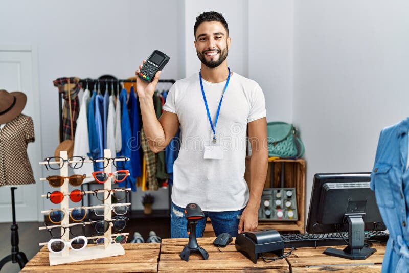 Young Arab Man Shopkeeper Holding Data Phone Working at Clothing Store ...