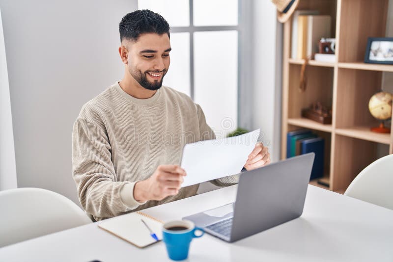 Young Arab Man Sitting on Table Studying at Home Stock Image - Image of ...