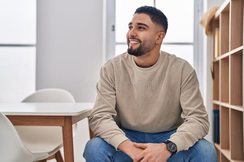 Young Arab Man Smiling Confident Sitting on Chair at Home Stock Image ...
