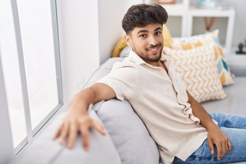 Young Arab Man Smiling Confident Sitting on Sofa at Home Stock Image ...