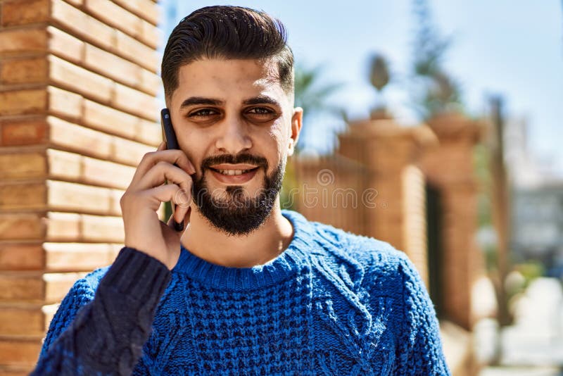 Young Arab Man Smiling Confident Talking on the Smartphone at Street ...