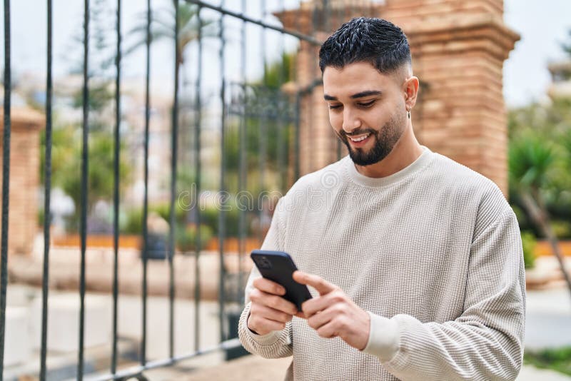 Young Arab Man Smiling Confident Using Smartphone at Street Stock Image ...