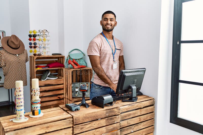 Young Arab Man Smiling Confident Working at Clothing Store Stock Photo ...
