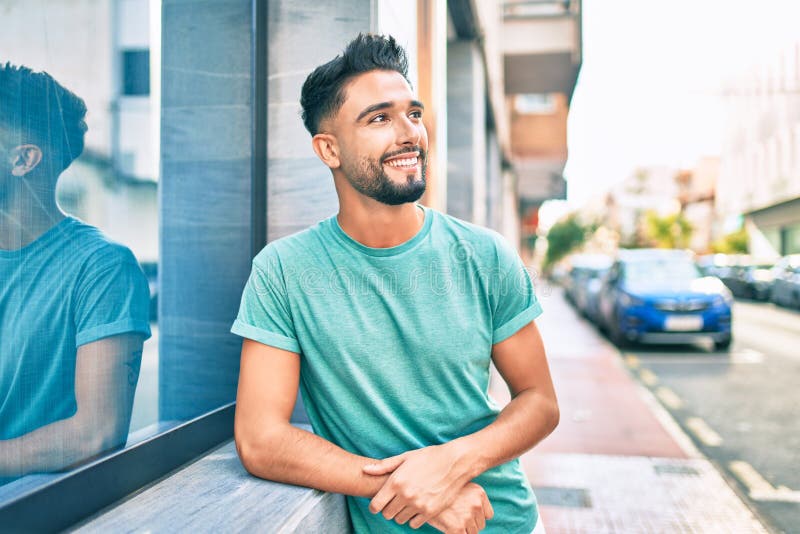 Young Arab Man Smiling Happy Leaning on the Wall at the City Stock ...