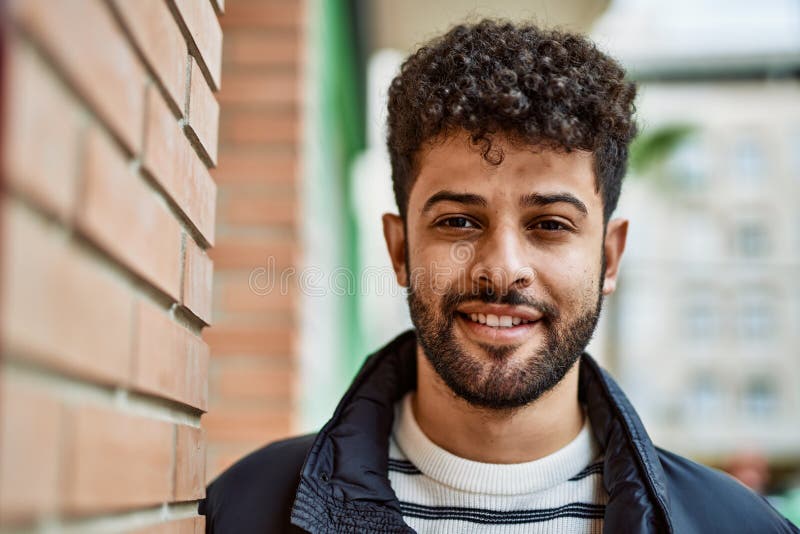Young Arab Man Smiling Leaning on Bricks Wall Stock Image - Image of ...