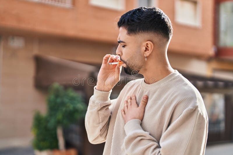 Young Arab Man Smoking with Relaxed Expression at Street Stock Image ...
