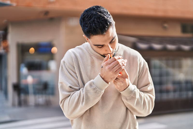 Young Arab Man Smoking with Relaxed Expression at Street Stock Photo ...