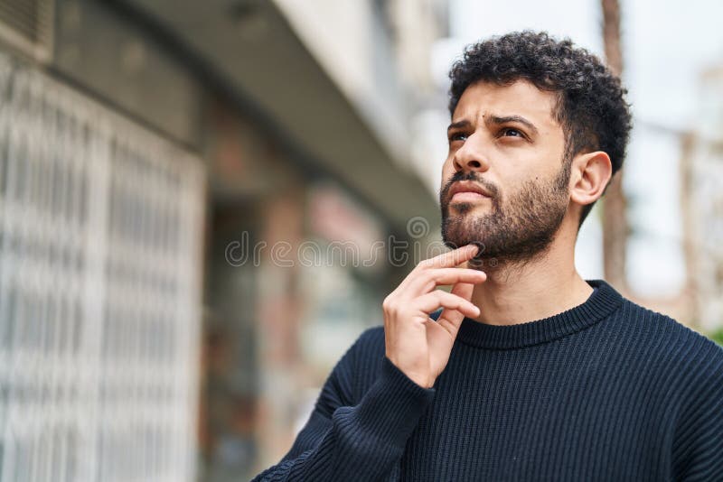Young Arab Man Standing with Doubt Expression at Street Stock Image ...