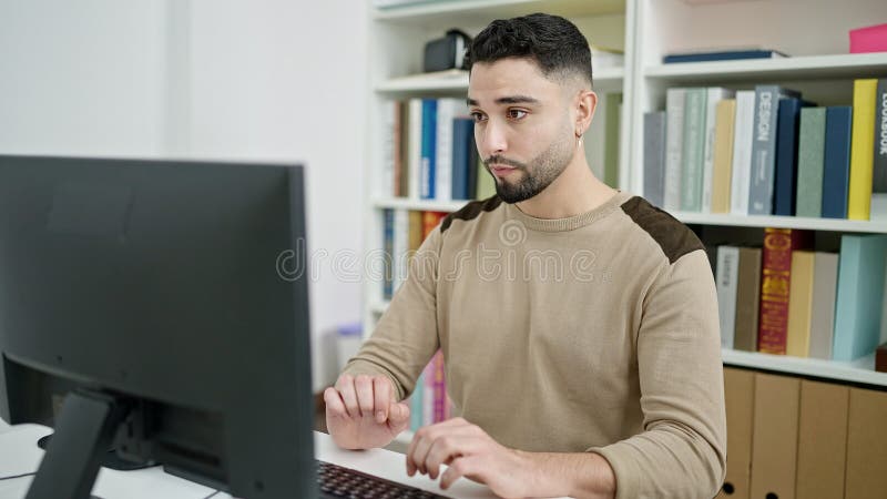 Young Arab Man Student Using Computer Studying at University Classroom ...