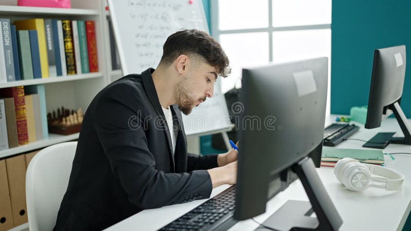 Young Arab Man Student Using Computer Writing on Notebook at University ...