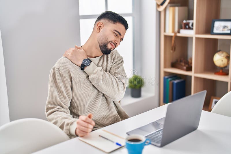 Young Arab Man Suffering for Back Ache Sitting on Table Working at Home ...