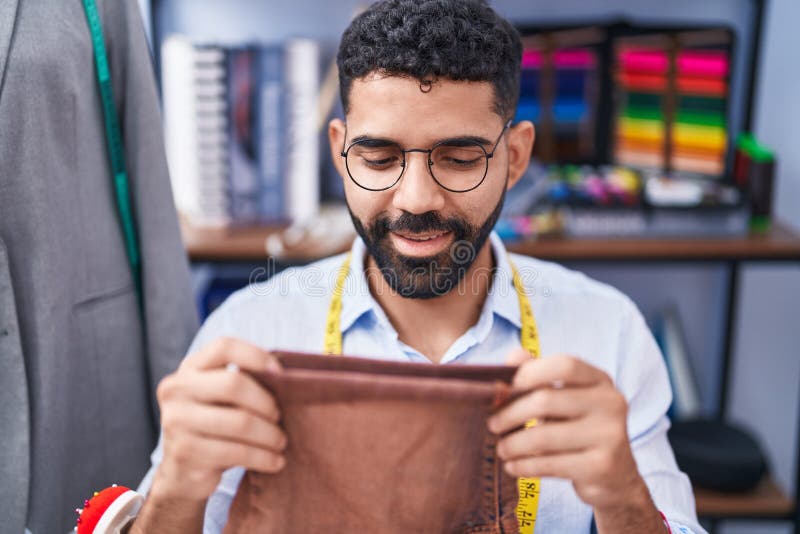 Young Arab Man Tailor Smiling Confident Holding Jeans at Tailor Shop ...