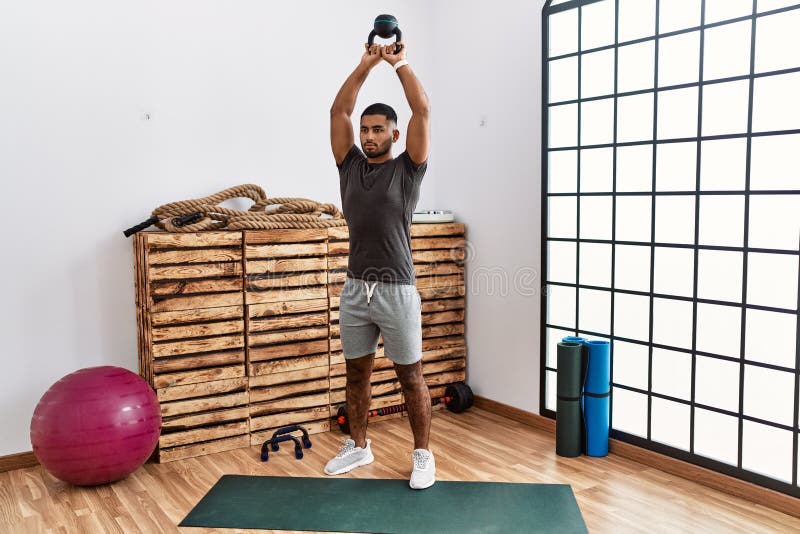 Young Arab Man Training with Kettlebell at Sport Center Stock Photo ...