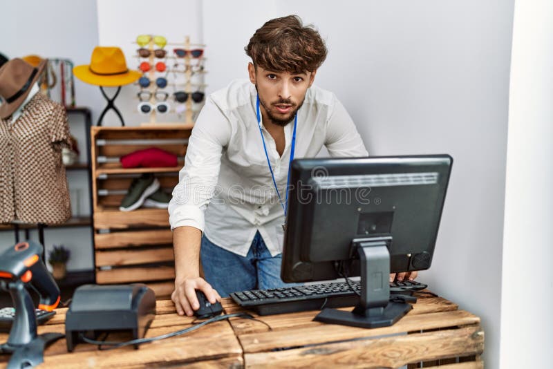 Young Arab Man Using Computer Working at Clothing Store Stock Photo ...