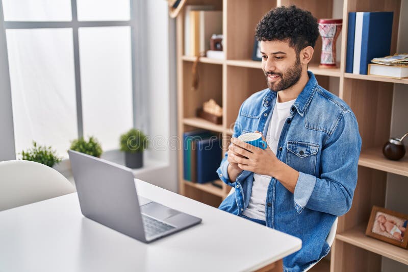 Young Arab Man Using Laptop Drinking Coffe Sitting on Table at Home ...
