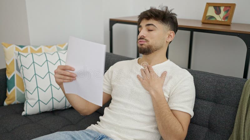 Young Arab Man Using Paper As a Hand Fan for Hot at Home Stock Image ...
