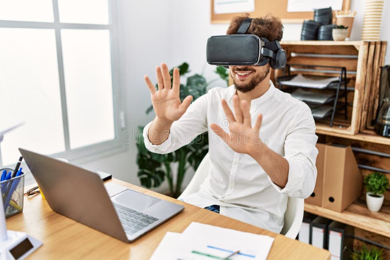 Young Arab Man Using Vr Goggles Doing Guitar Gesture at Office Stock ...