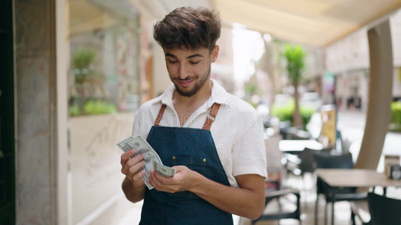 Young Arab Man Waiter Counting Dollars Working at Restaurant Stock ...