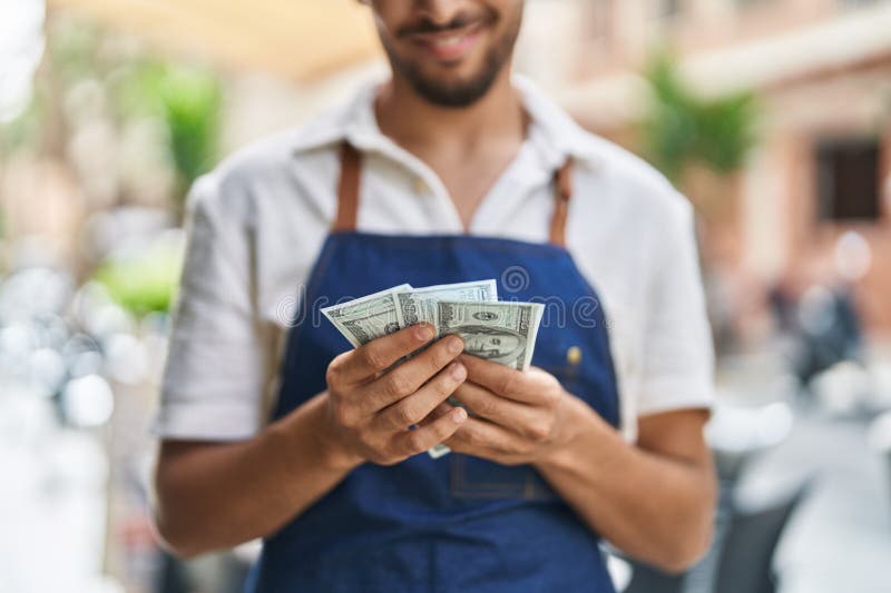 Young Arab Man Waiter Counting Dollars Working at Restaurant Stock ...