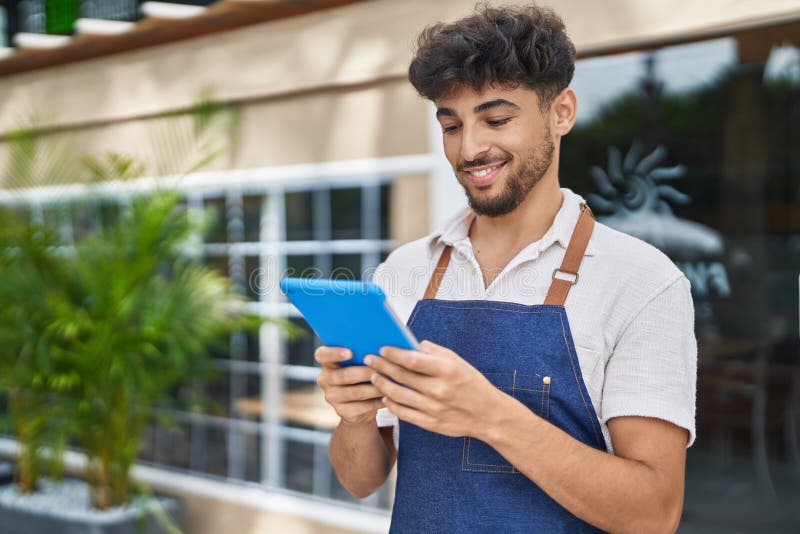 Young Arab Man Waiter Using Touchpad Working at Restaurant Stock Photo ...