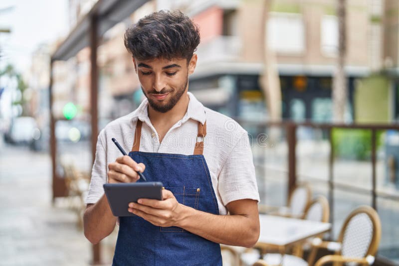 Young Arab Man Waiter Using Touchpad Working at Restaurant Stock Photo ...