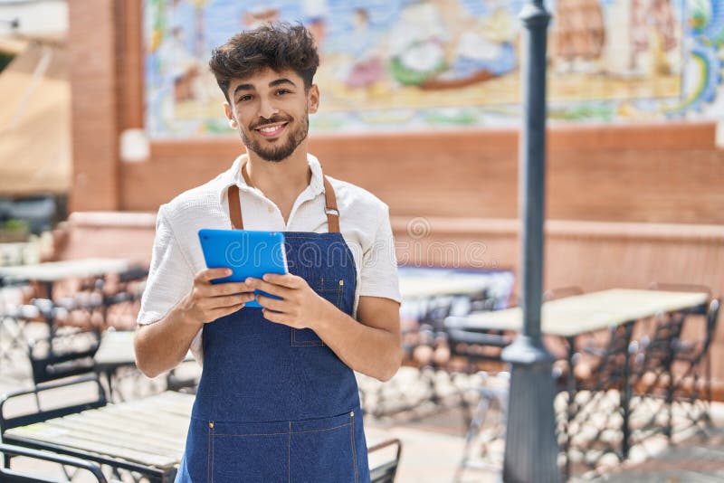Young Arab Man Waiter Using Touchpad Working at Restaurant Stock Image ...