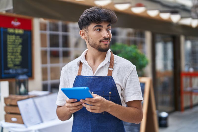 Young Arab Man Waiter Using Touchpad Working at Restaurant Stock Image ...