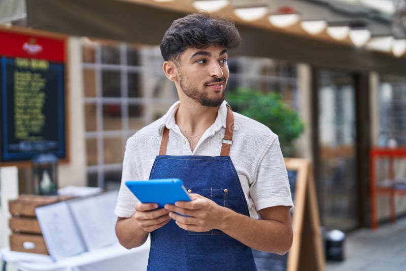 Young Arab Man Waiter Using Touchpad Working at Restaurant Stock Image ...