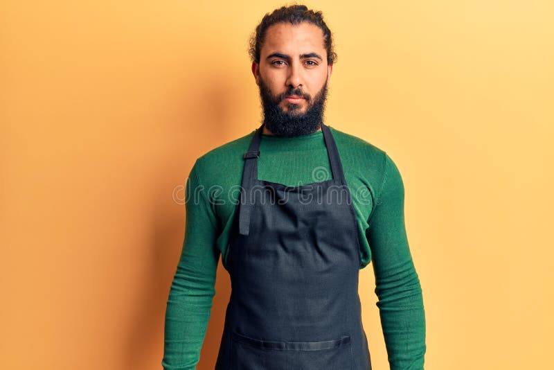Young Arab Man Wearing Barber Apron with Serious Expression on Face ...
