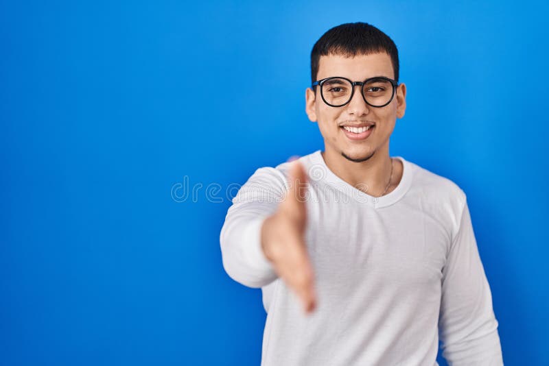 Young Arab Man Wearing Casual White Shirt And Glasses Smiling Friendly
