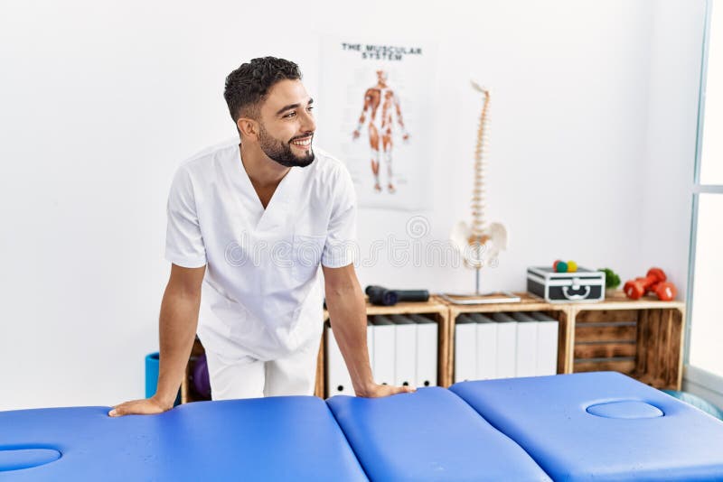Young Arab Man Wearing Physiotherapist Uniform Standing at Clinic Stock ...