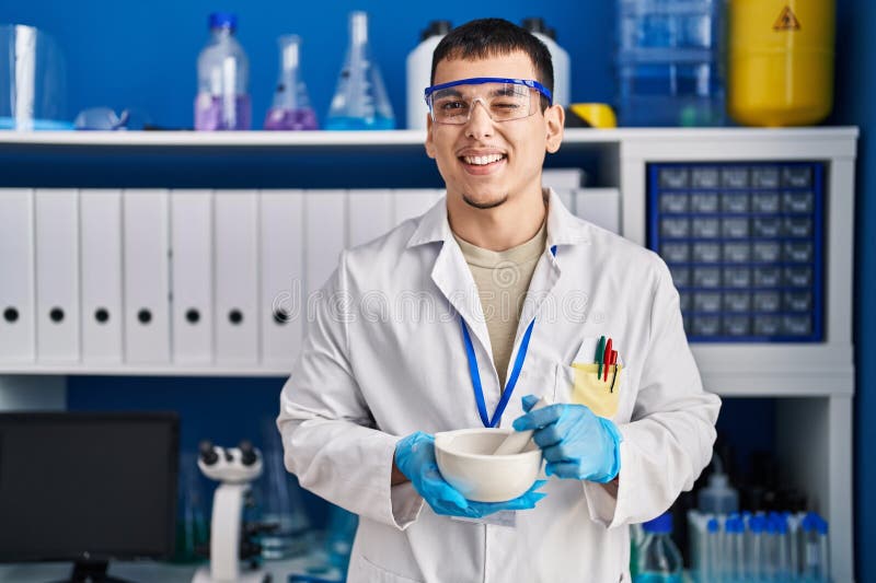 Young Arab Man Working at Scientist Laboratory Winking Looking at the ...