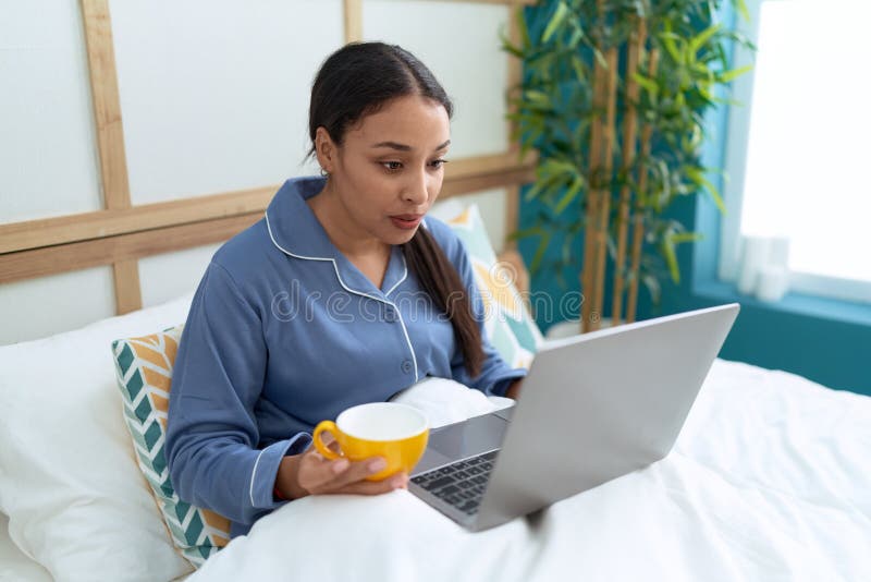 Young Arab Woman Using Laptop Drinking Coffee at Bedroom Stock Image ...