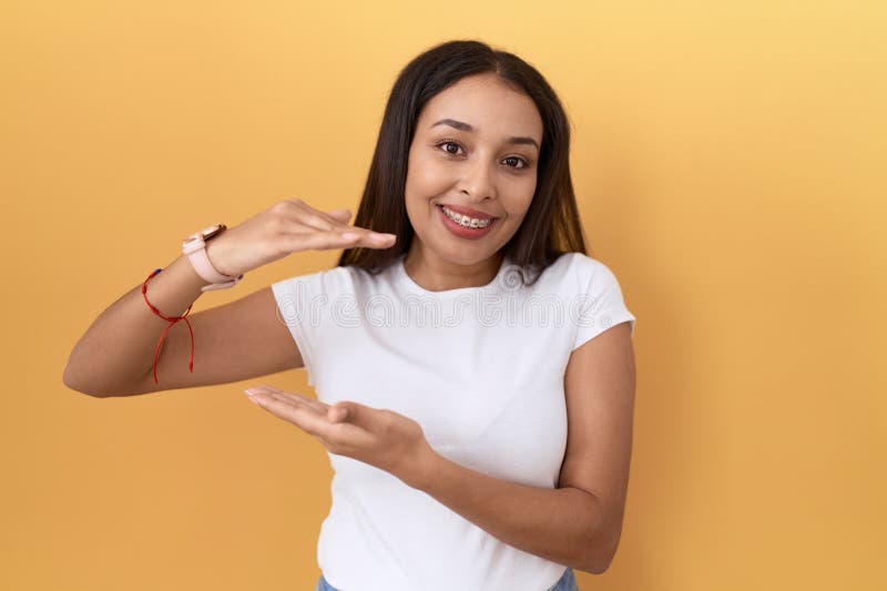 Young Arab Woman Wearing Casual White T Shirt Over Yellow Background