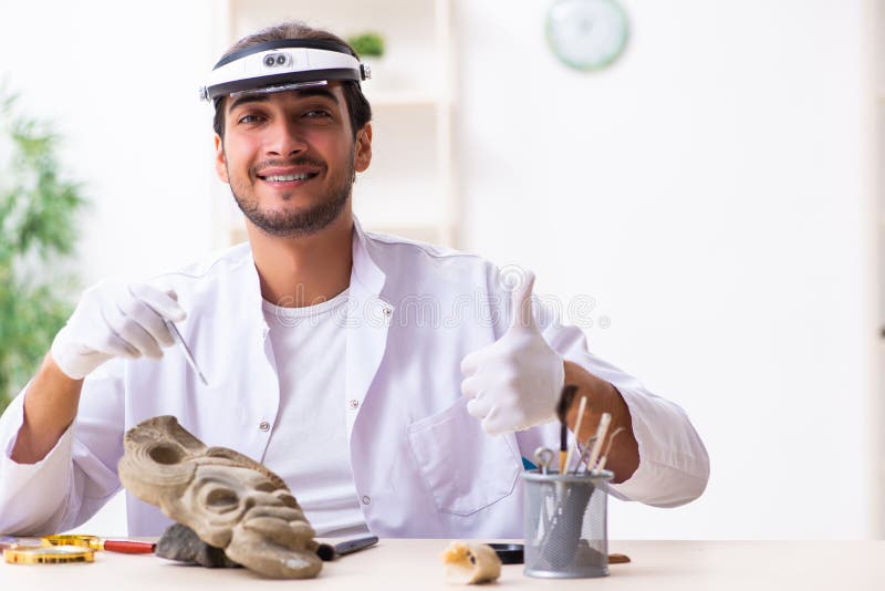 Young Male Archaeologist Studying Ancient African Stonemask Stock Image ...