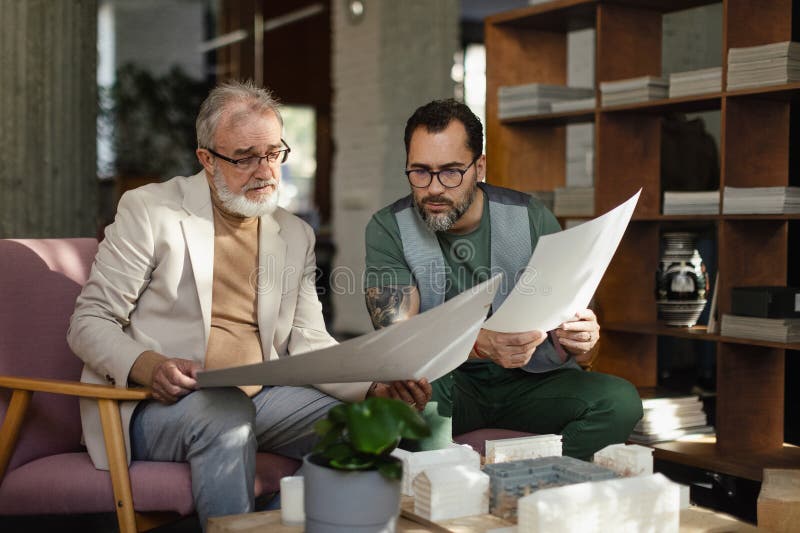 Young Architect Consulting Project with Senior Client. Stock Photo ...