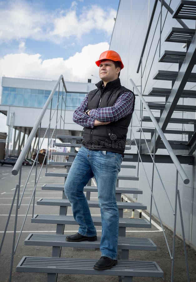 Architect in Hard Hat Standing with Blueprint in Office Corridor Stock ...