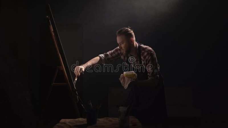 Young Artist Covers the Canvas with a Primer before Starting Work on ...
