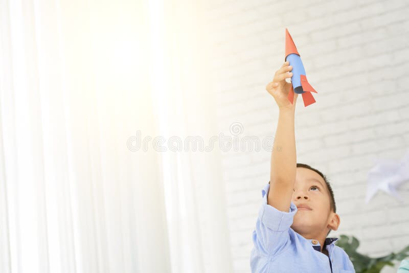 Creative Kid with Rocket in Raised Hand Stock Photo - Image of ...