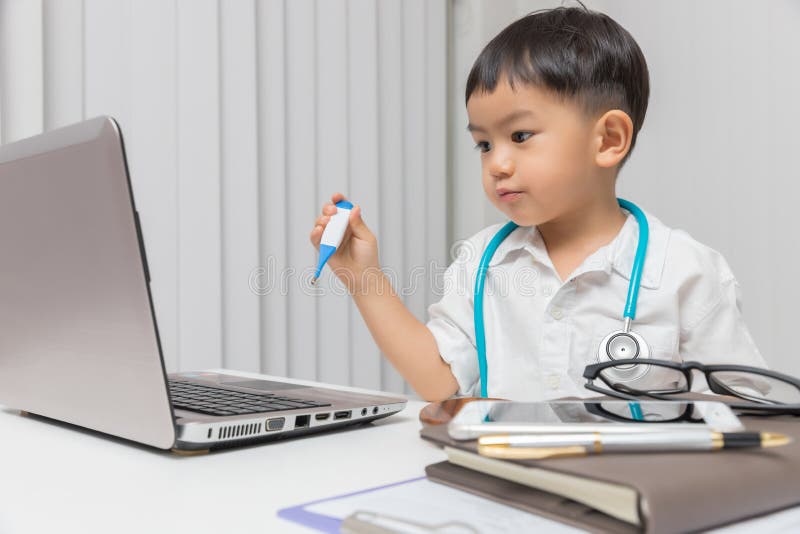 Young Asian Boy Playing Doctor and Using Computer Laptop Stock Image ...