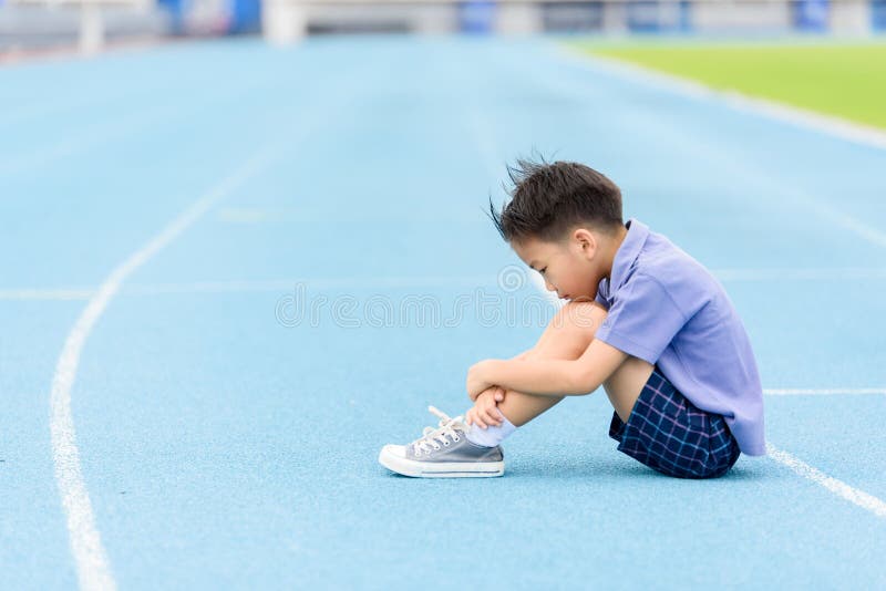 Young Asian Boy Sit on Blue Track in the Stadium Stock Image - Image of ...