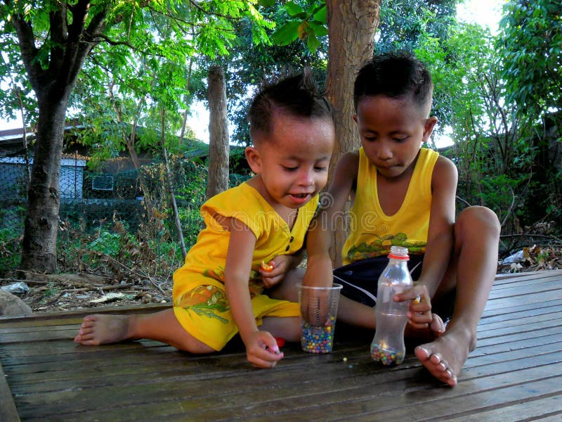 Young Asian Boys Playing Under a Tree Editorial Stock Image - Image of ...