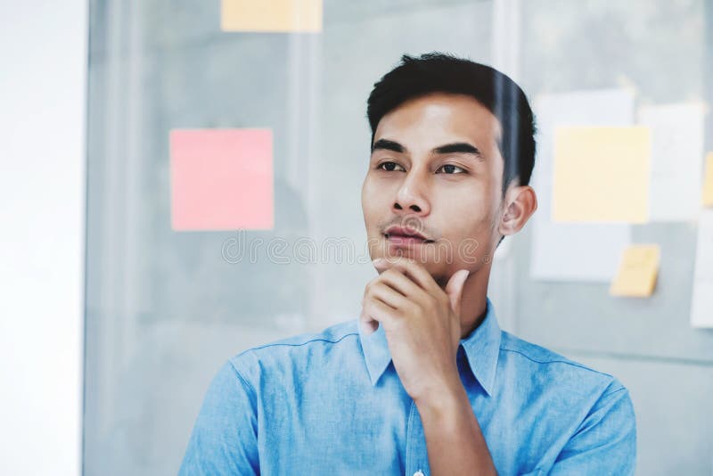 Young Asian Businessman Working in Office Meeting Room. Man Analyzing ... Young Asian Businessman Working in Office Meeting Room. Man Analyzing ...