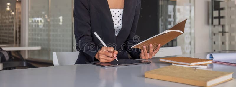 Young Asian Businesswoman Taking Notes Using a Laptop at the Modern ...