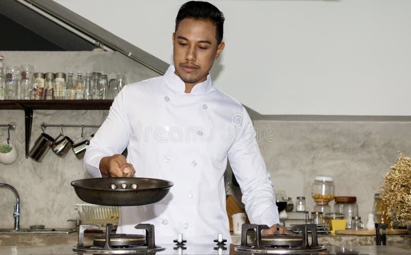 Young Asian Chef is Cooking in the Kitchen Stock Image - Image of ...