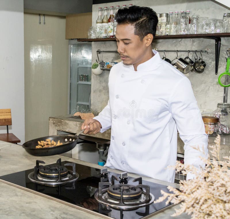 Young Asian Chef is Cooking in the Kitchen Stock Image - Image of ...